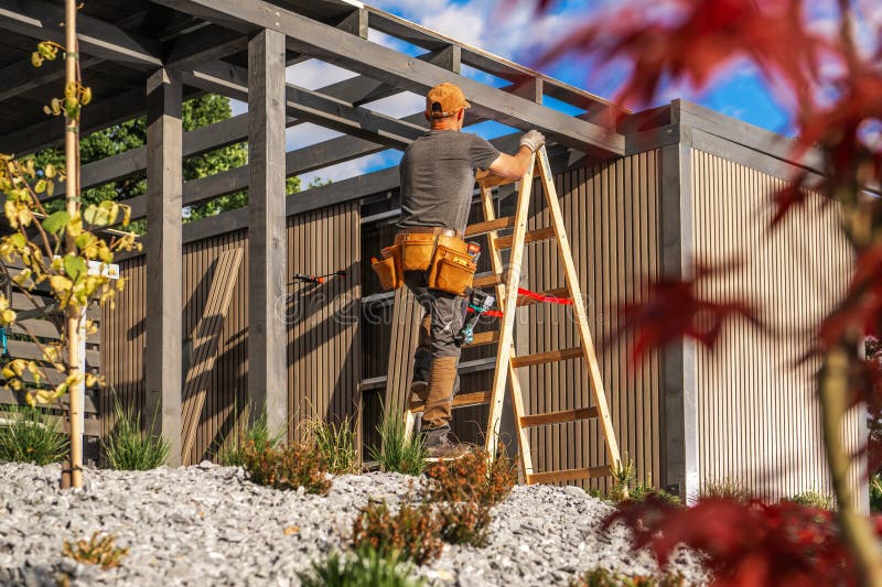 Construction Worker Climbs Ladder To Work on Modern Building in Sunny ...
