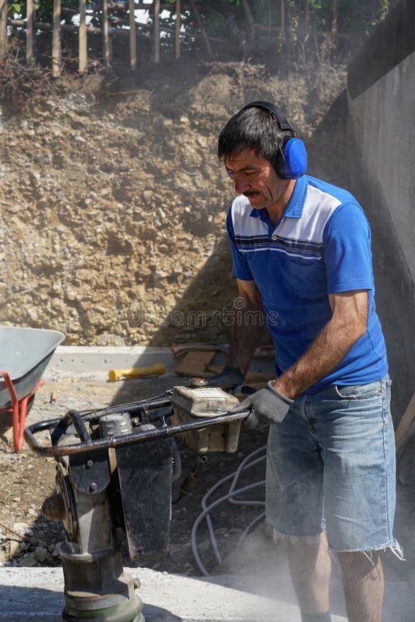 Construction Worker Compacting Soil Using Compactor Stock Image - Image ...