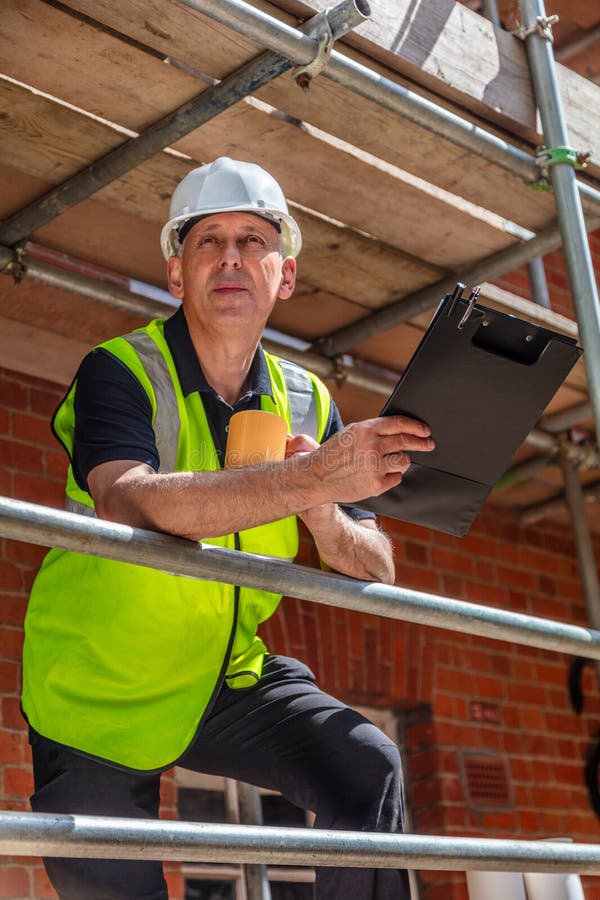 Construction Worker Contractor on Building Site Clipboard and Mug Stock ...