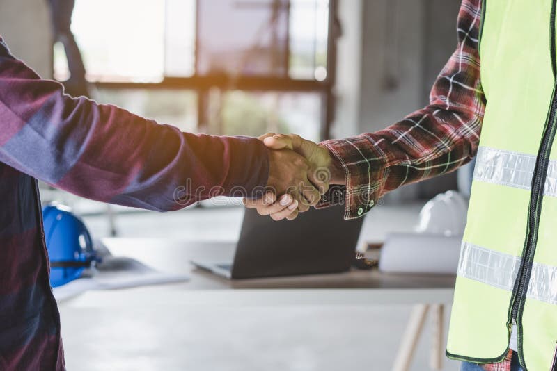 Construction Worker and Contractor. Client Shaking Hands with Team ...