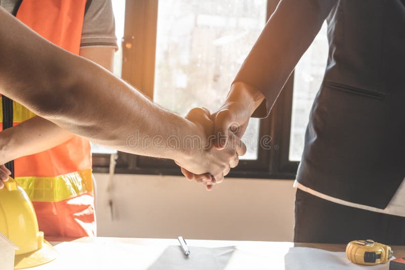 Construction Worker and Contractor. Client Shaking Hands with Team ... Construction Worker and Contractor. Client Shaking Hands with Team ...