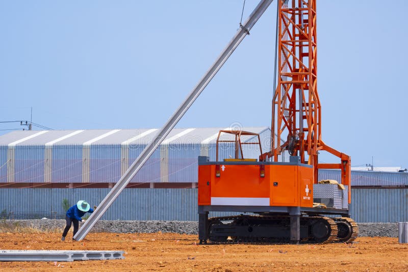 Construction Worker with Crawler Pile Driver Machine Lifting Concrete ...