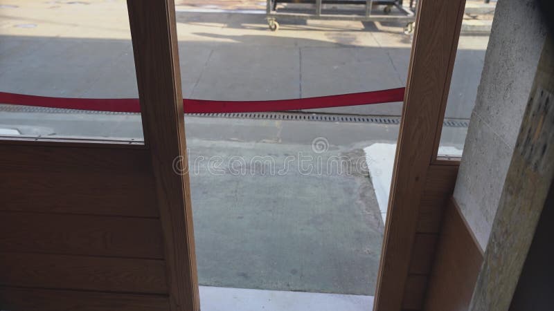 Construction Worker Crossing a Red Ribbon while Entering a Building ...