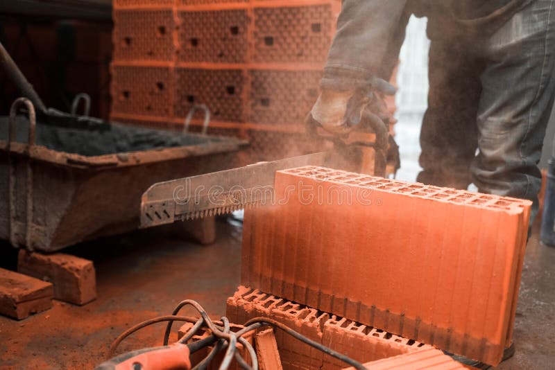 Construction Worker Cuts a Brick with a Saw Stock Photo - Image of ...