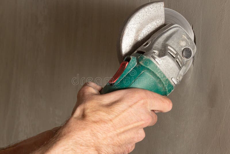 A Construction Worker Cuts a Concrete Wall with a Circular Saw with a ...