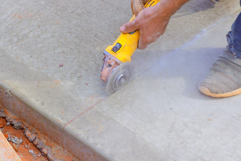 Construction Worker Cutting Concrete Foundations Using a Grinding ...