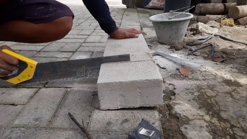A Construction Worker is Cutting Lightweight Bricks Stock Video - Video ...