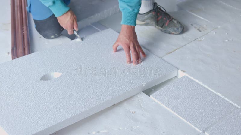 Construction Worker Cutting Styrofoam Insulation Panels for Floor Stock ...