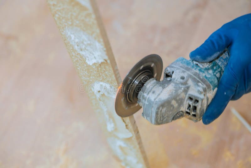A Construction Worker Cutting a Tile Using Grinder Stock Photo - Image ...