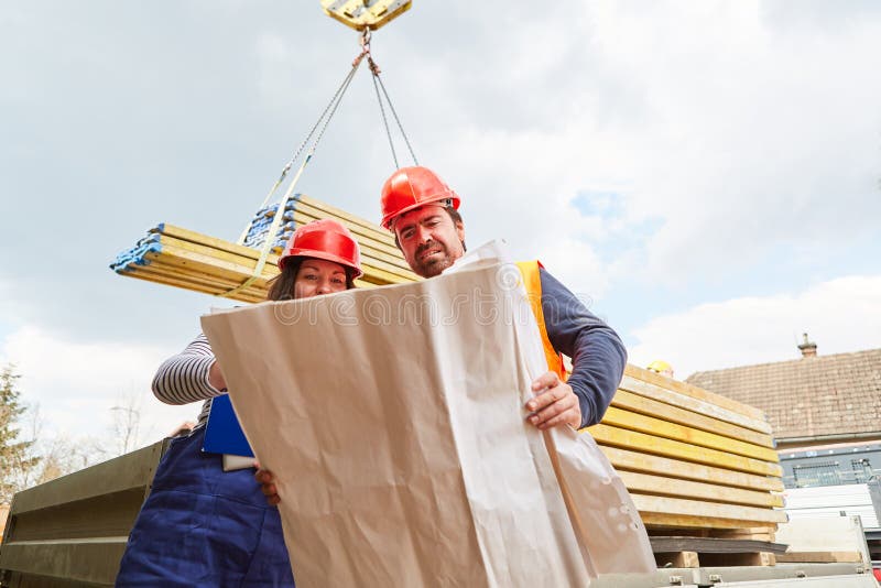 Construction Worker with Delivery of Building Materials in the ...
