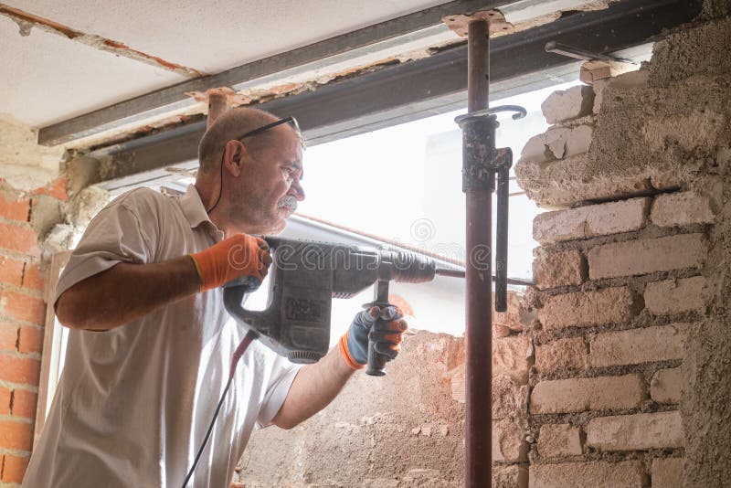 Mason Breaking a House Wall with a Demolition Hammer. Stock Image ...