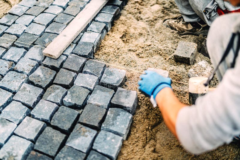 Construction Worker.Building of Road or Sidewalk with Granite Stone As ...