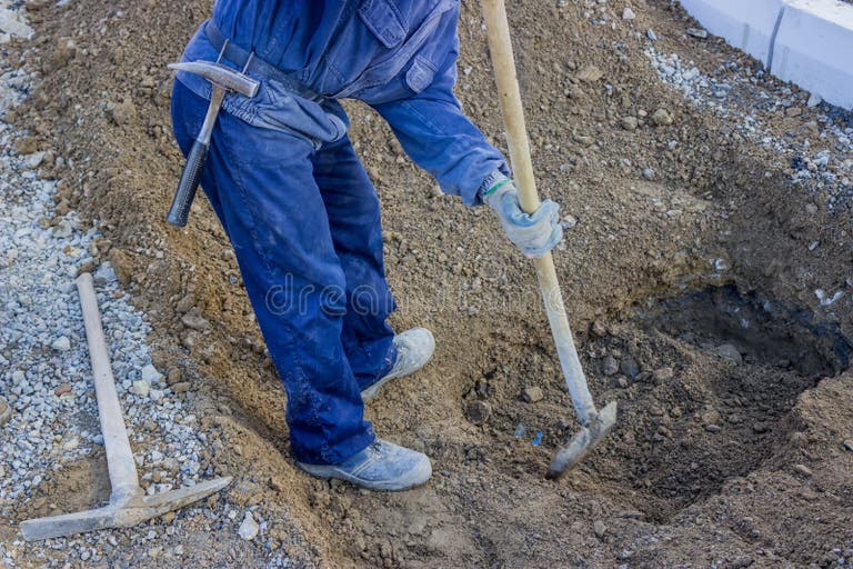 Construction Worker Digging a Deep Underground Hole with a Shove Stock ...