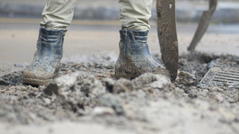 Construction Worker Digging in Muddy Ground at City Site Stock Video ...
