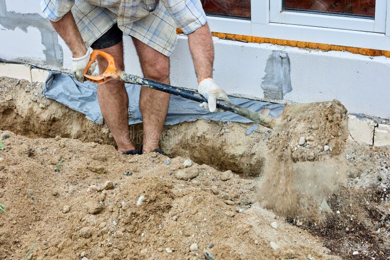 Digging Trench for Laying Cable, Construction Worker Uses Shovel To ...