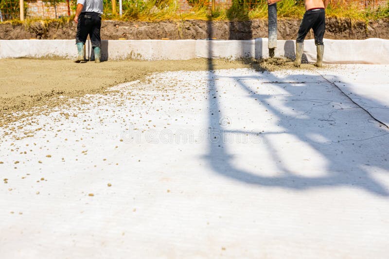 Rigger, Worker is Holding Pump Hose To Pouring Fresh Concrete into ...