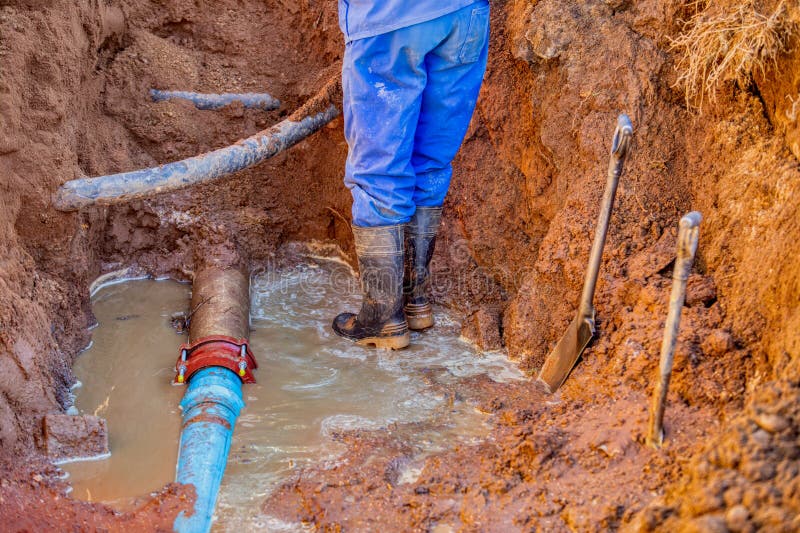 Construction Worker Doing Some Trench Digging, Metal Pipe Repairing ...