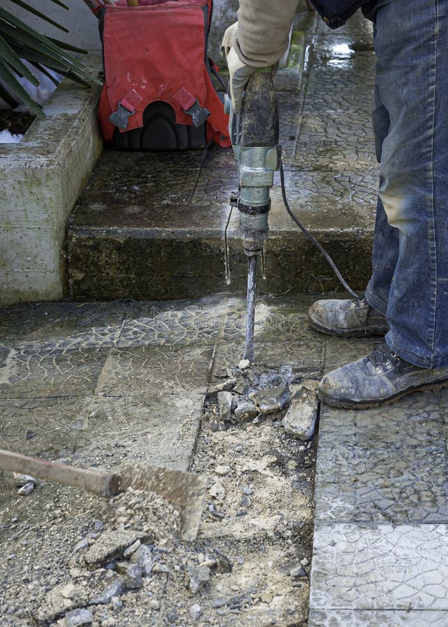 The Construction Worker is Drilling the Floor. Stock Image - Image of ...
