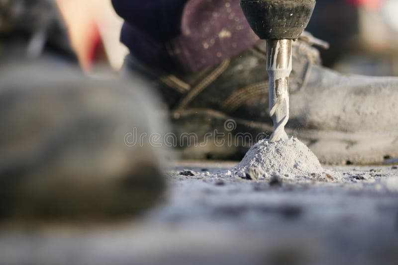 Construction Worker Drills into Concrete at a Building Site Stock Photo ...