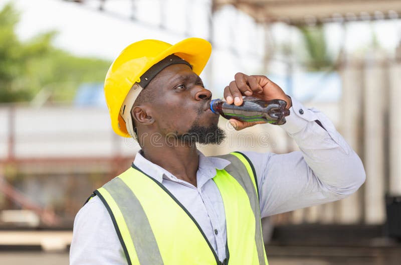 Construction Worker Drinking Cola from a Bottle on a Site, Worker Man ...