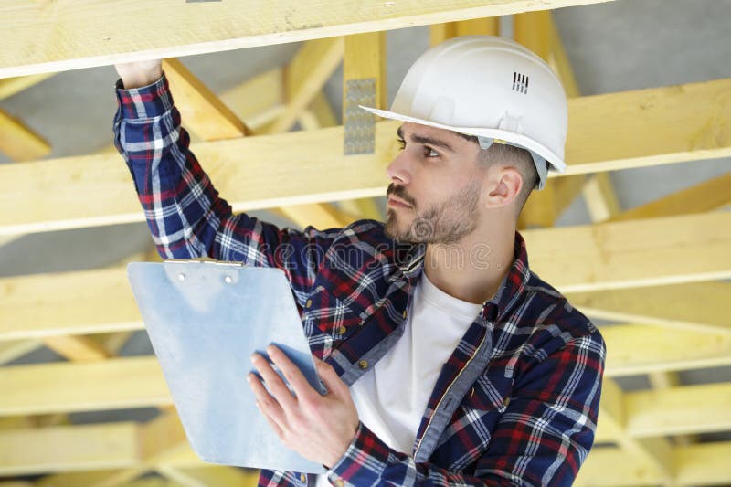 Construction Worker on Duty in Wooden House Frame Stock Image - Image ...