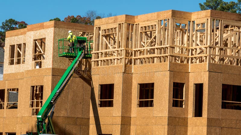 Worker on an Elevated Construction Platform on Modern Building D Stock ...