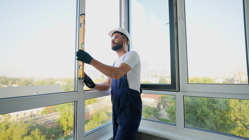 Construction Worker Ensuring Window Alignment with Spirit Level Stock ...
