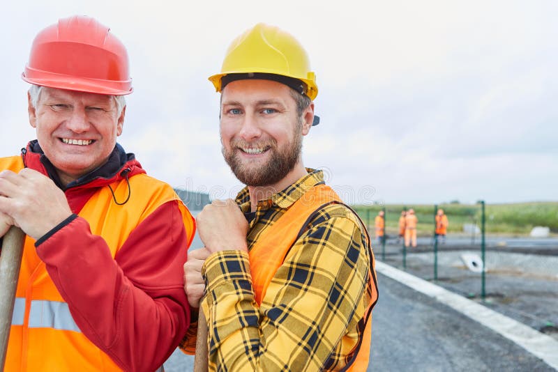 Construction Worker with Experience and a Young Colleague Stock Image ...
