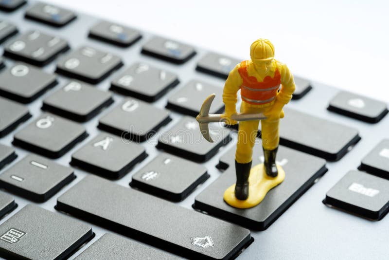 Construction Worker Figurine with a Pickaxe Standing on Top of a Simple ...