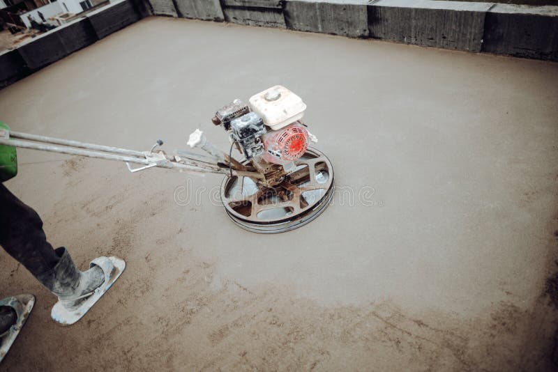 Construction Worker Finishing Concrete Screed with Power Trowel Machine ...