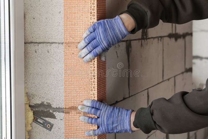Construction Worker Fixing Fiberglass Corner Reinforcement Mesh during ...