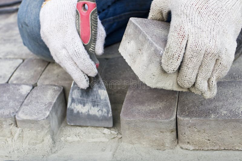 Construction Worker Fixing the Pavestone Stock Image - Image of gloves ...