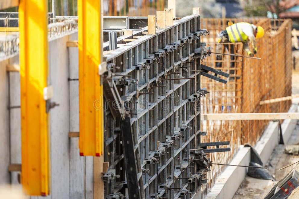 Construction Worker Assembling Concrete Forms on a Building Site Stock ...