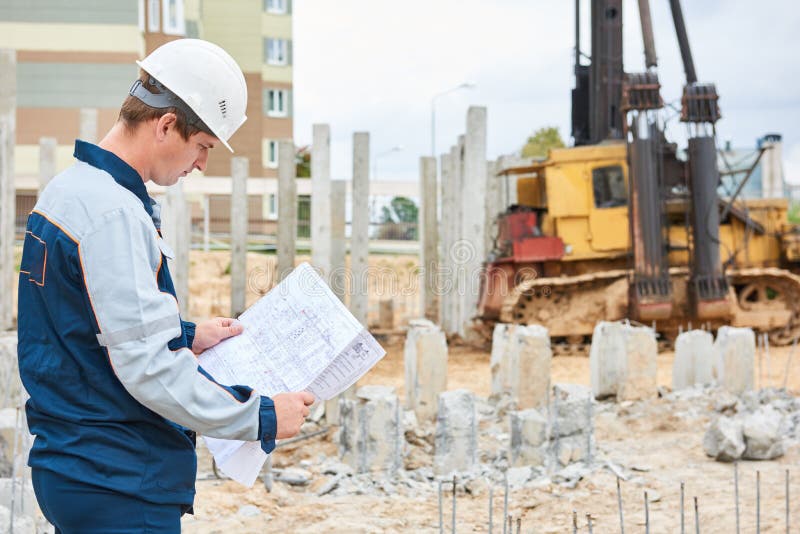 Foreman Builder And Construction Worker With Blueprint In Indoor ...
