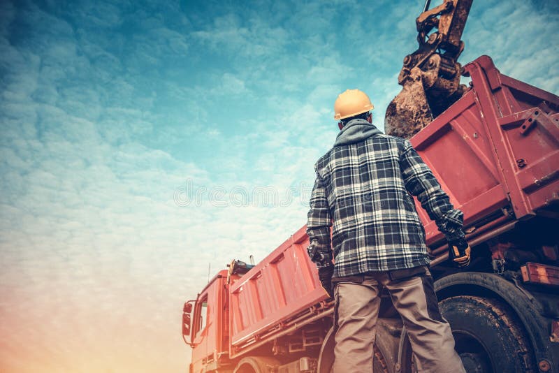 Construction Worker in Front of Dump Truck Loaded by Excavator Stock ...