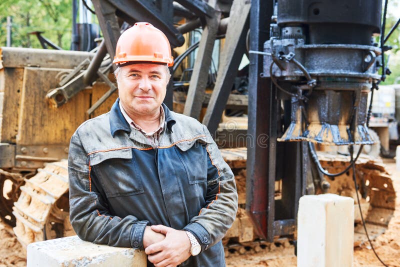 Construction Worker in Front of Pile Driver Machine Stock Image - Image ...