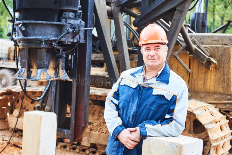 Construction Worker in Front of Pile Driver Machine Stock Photo - Image ...