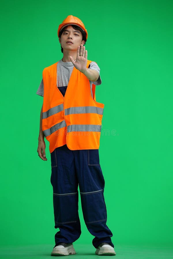 A Construction Worker Guy, on a Green Background, in Full Height, Shows ...