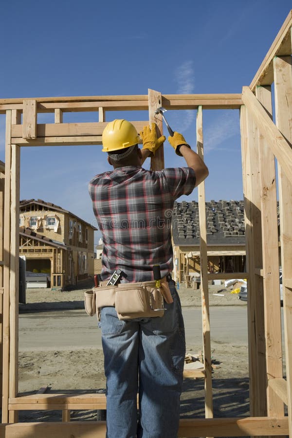 Construction Worker Hammering Nail on Timber Frame Stock Photo - Image ...