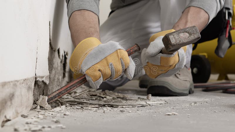 Construction Worker Hands with Gloves Working with Hammer and Chisel To ...