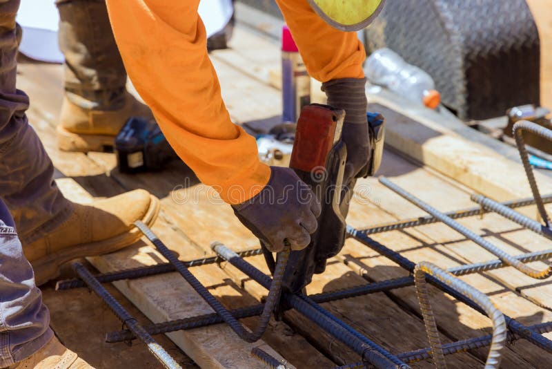 Construction Worker Hands Securing Steel Bars with Wire Rods for Cement ...