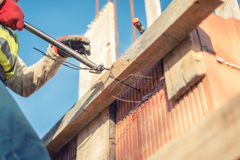 Construction Worker Hands Securing Wooden Boards with Wire Rod Stock ...