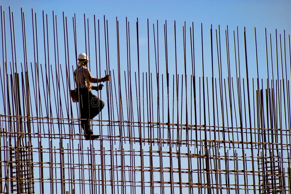 Construction Worker in Hard Hat Standing on Rows of Thin Rebar Stock ...