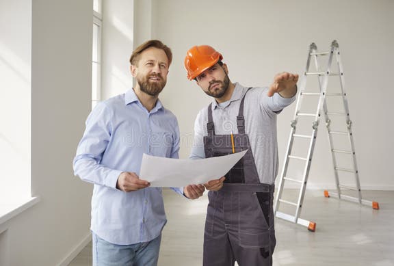 Construction Worker with Blueprint Discussing Renovation Plan with ...