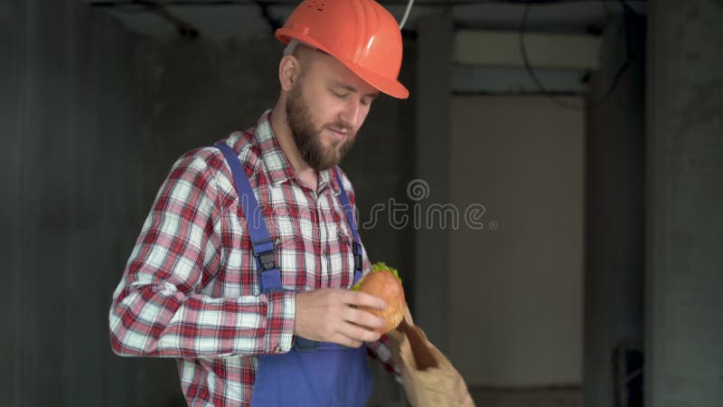 Construction Worker in Helmet Eating Burger during Lunch Break Stock ...