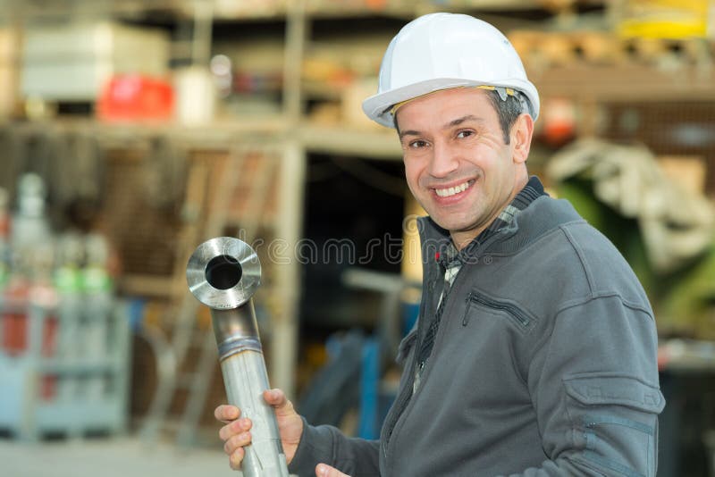 Construction Worker with Helmet and Pipe Looking at Camera Stock Image ...