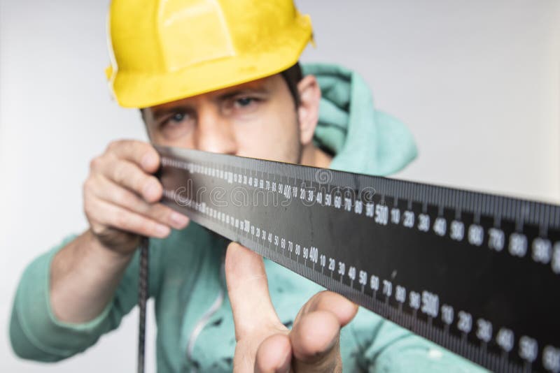 The Construction Worker is Holding a Angle in the Hand, a Guide To ...