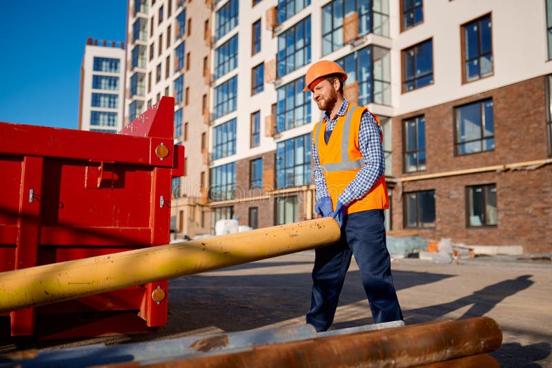 Construction Worker Holding Pipe on Site Outdoors Stock Image - Image ...