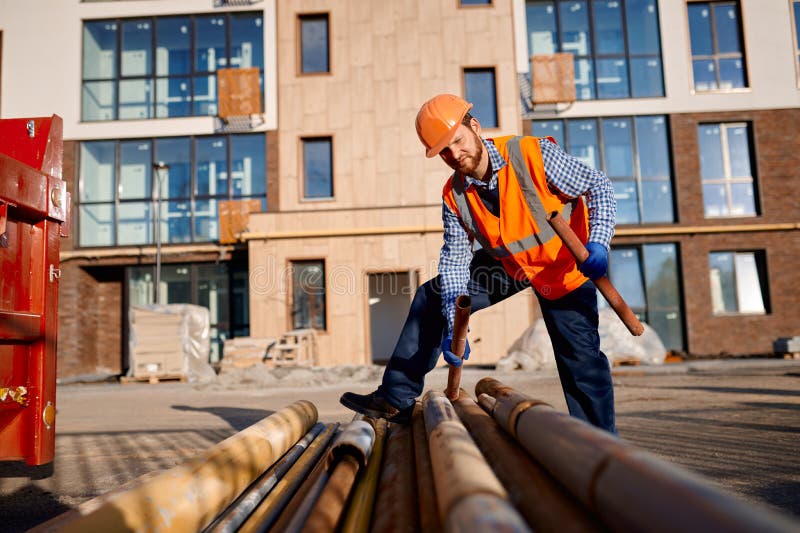 Construction Worker Holding Pipe on Site Outdoors Stock Image - Image ...