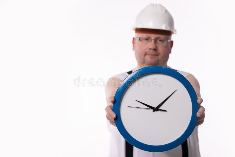 A Construction Worker Holds a Clock, Symbolizing Their Commitment To ...